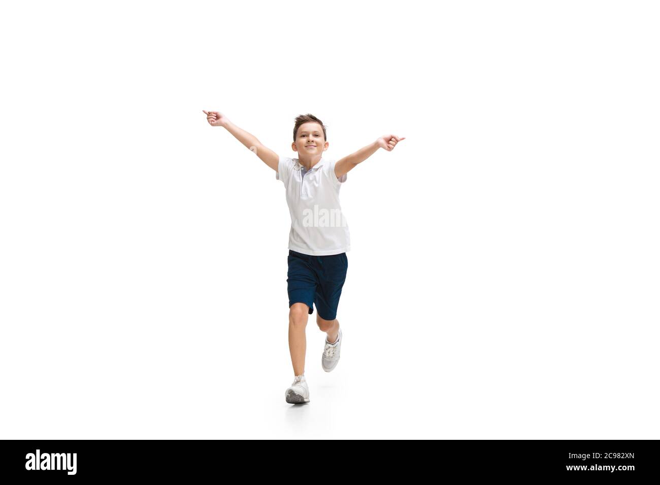 Happy kids, little and emotional caucasian boy jumping and running ...