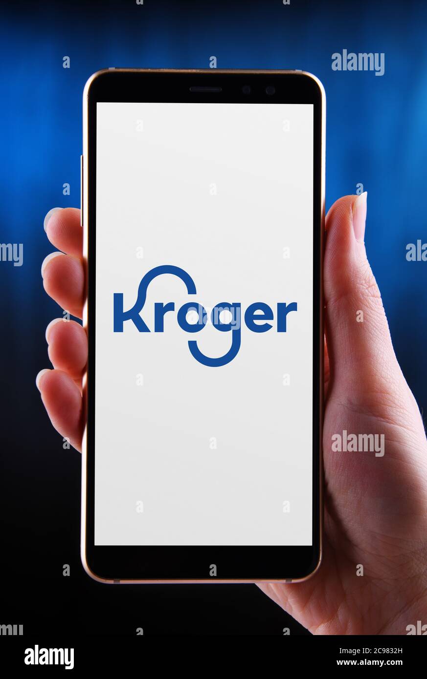 POZNAN, POL - MAY 21, 2020: Hands holding smartphone displaying logo of ...