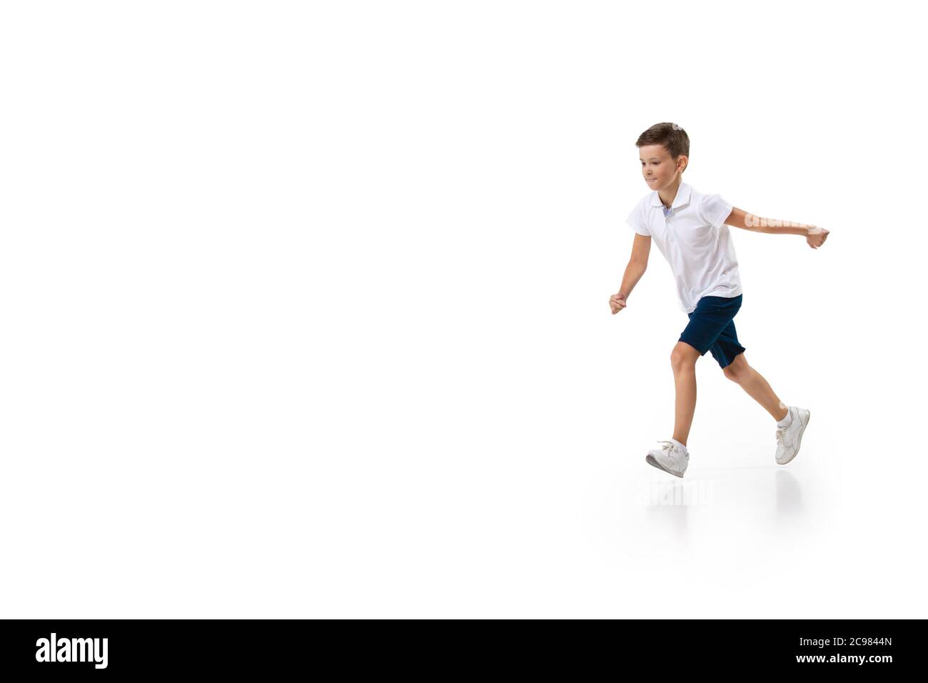Happy kids, little and emotional caucasian boy jumping and running ...