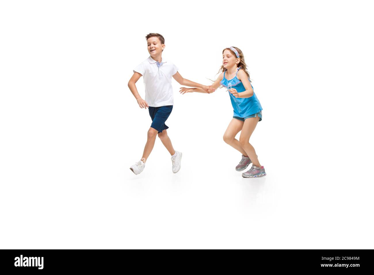 Happy kids, little and emotional caucasian boy and girl jumping and ...