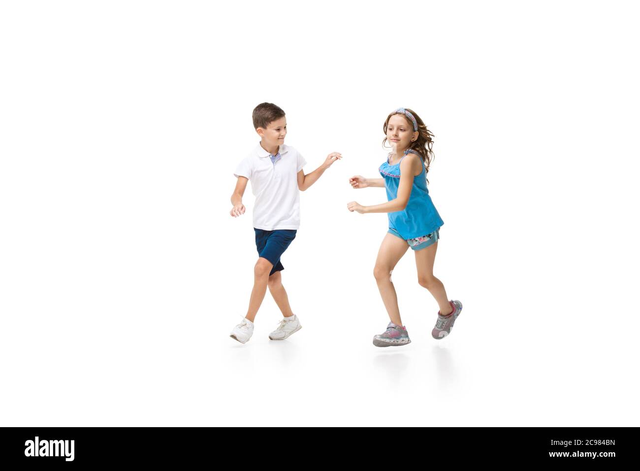 Happy kids, little and emotional caucasian boy and girl jumping and ...