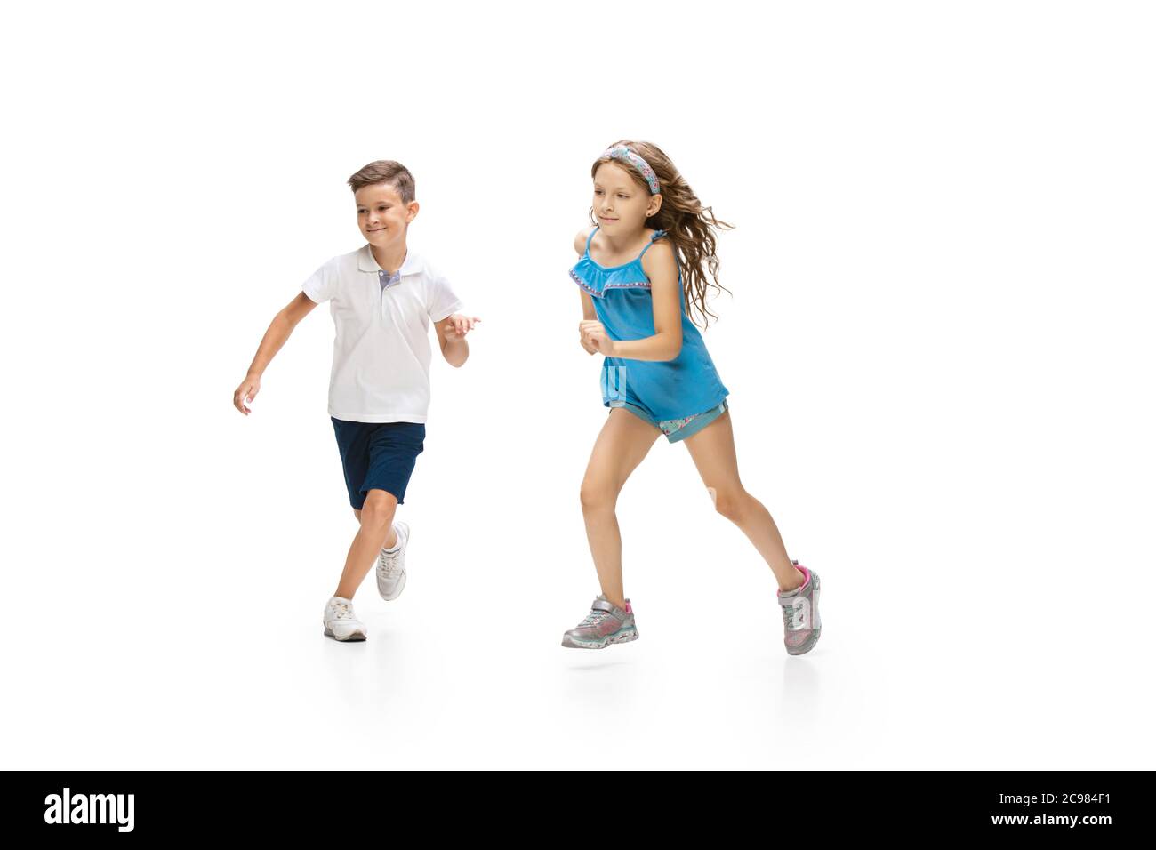 Happy kids, little and emotional caucasian boy and girl jumping and ...