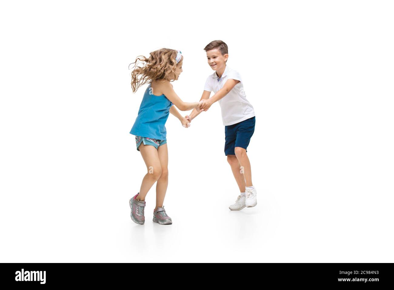 Happy kids, little and emotional caucasian boy and girl jumping and ...