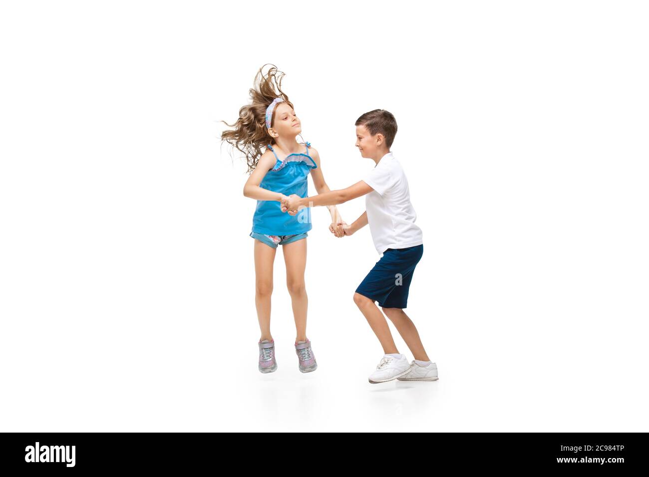 Happy kids, little and emotional caucasian boy and girl jumping and ...