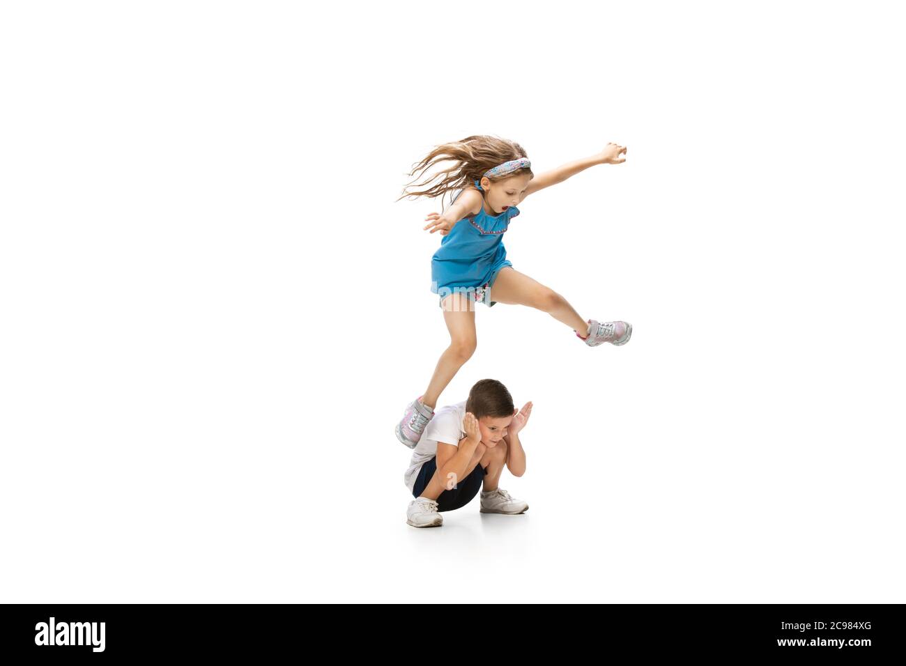 Happy kids, little and emotional caucasian boy and girl jumping and ...