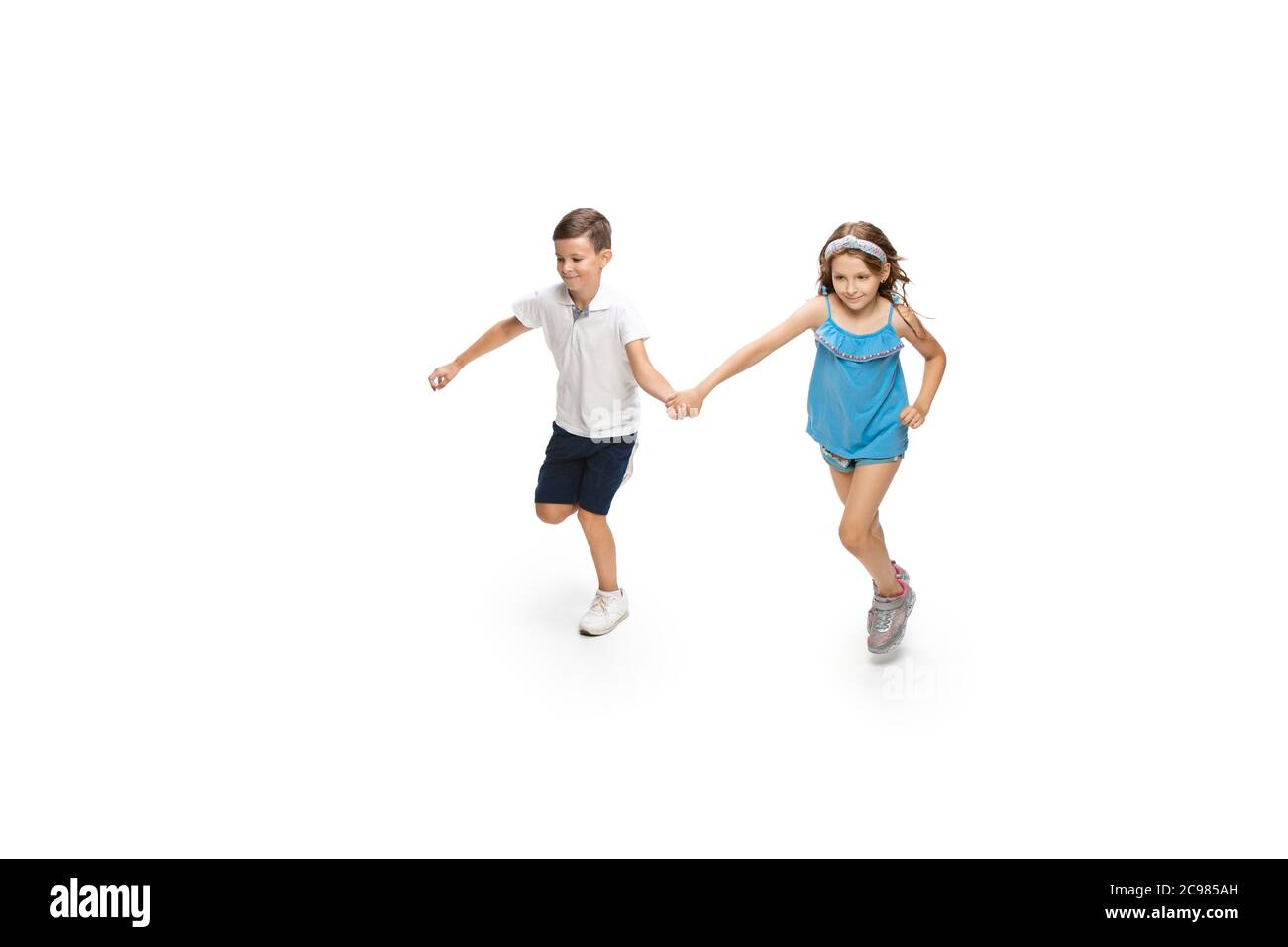 Happy kids, little and emotional caucasian boy and girl jumping and ...