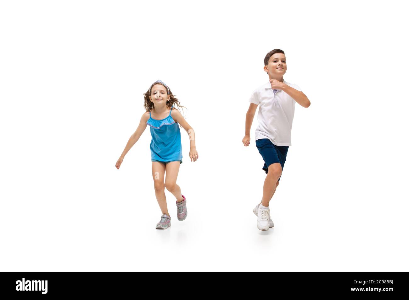 Happy kids, little and emotional caucasian boy and girl jumping and ...