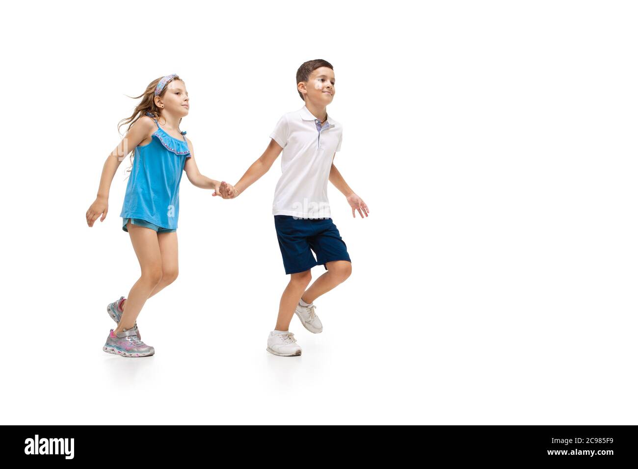Happy kids, little and emotional caucasian boy and girl jumping and ...