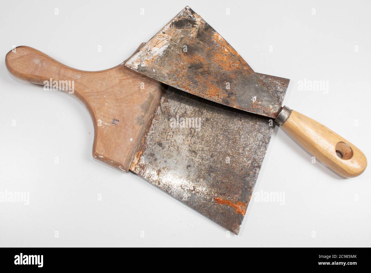 two old painter's spatula with rust and use marks with wooden handle on ...