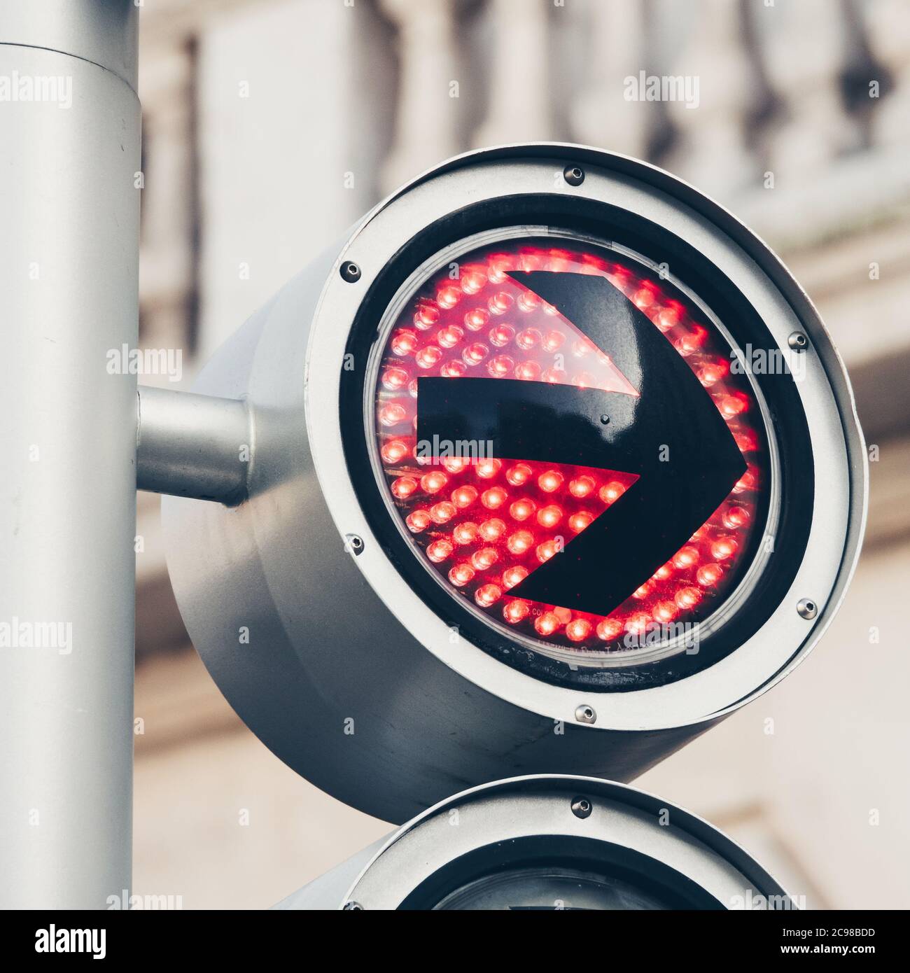 Closeup shot of a round illuminated red sign with a black arrow Stock ...