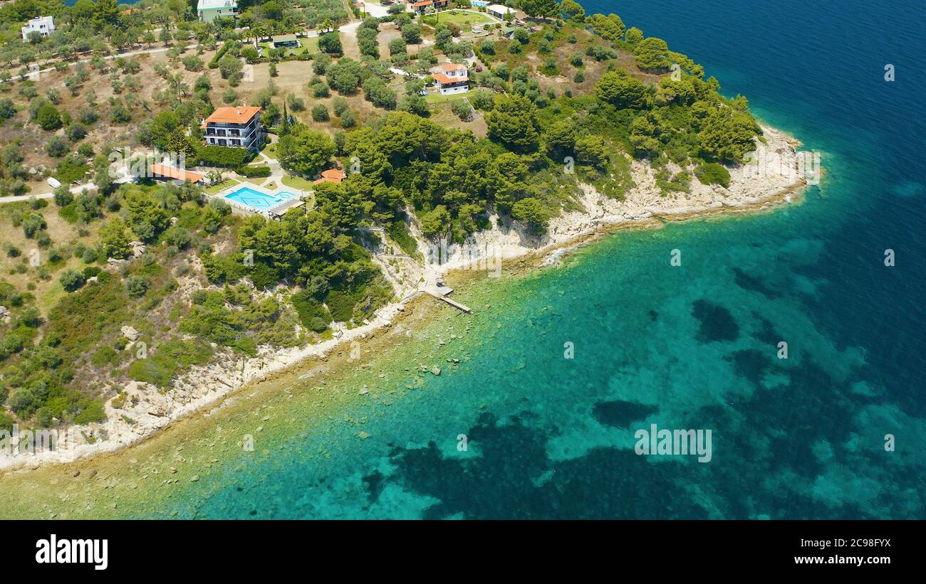 Aerial view of a blue ocean near a cliffy shore at daytime Stock Photo ...
