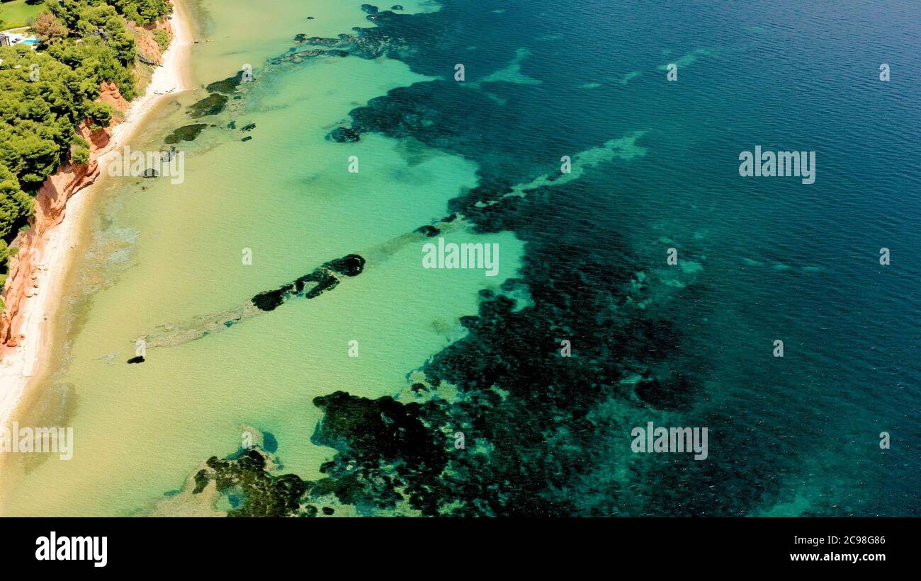 Aerial view of a blue ocean near a cliffy shore at daytime Stock Photo ...
