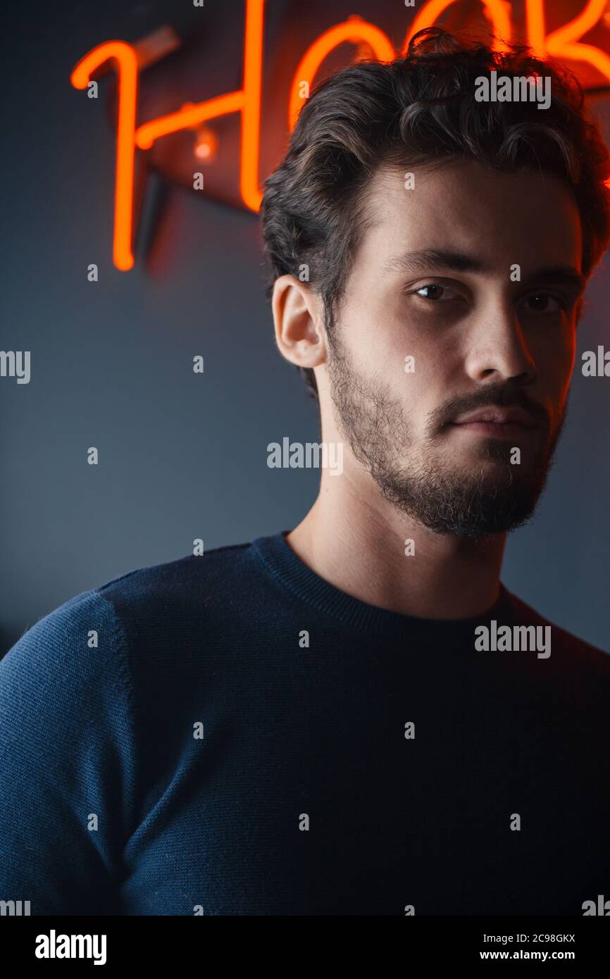 good looking strong slim man with black short wavy hair posing at the ...