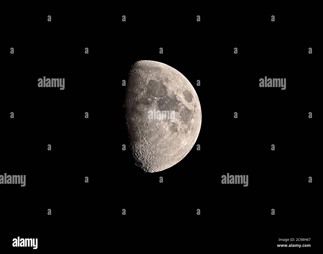Half moon showing craters and many details on the surface Stock Photo ...