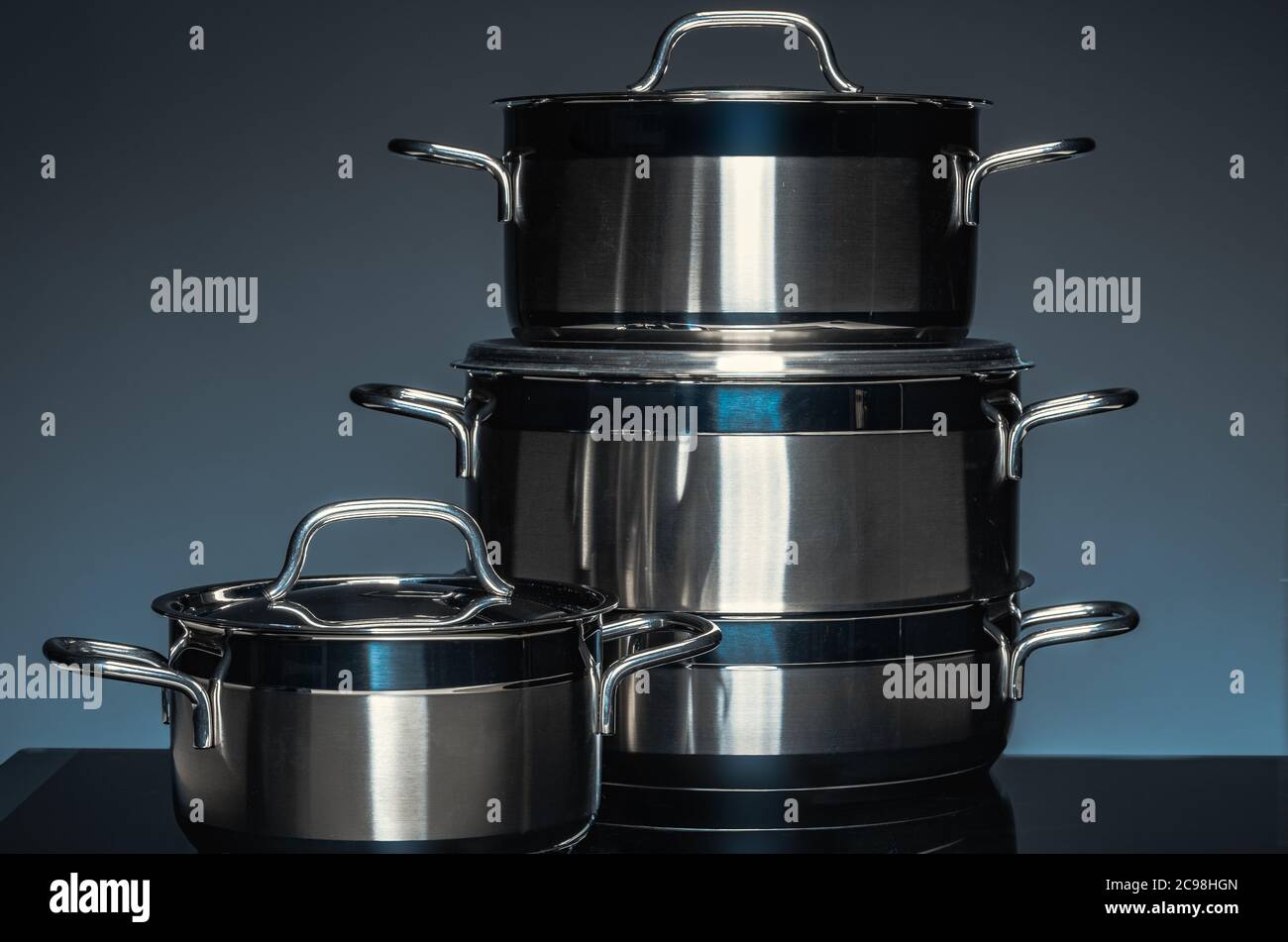 New cookware on black background, front view Stock Photo - Alamy