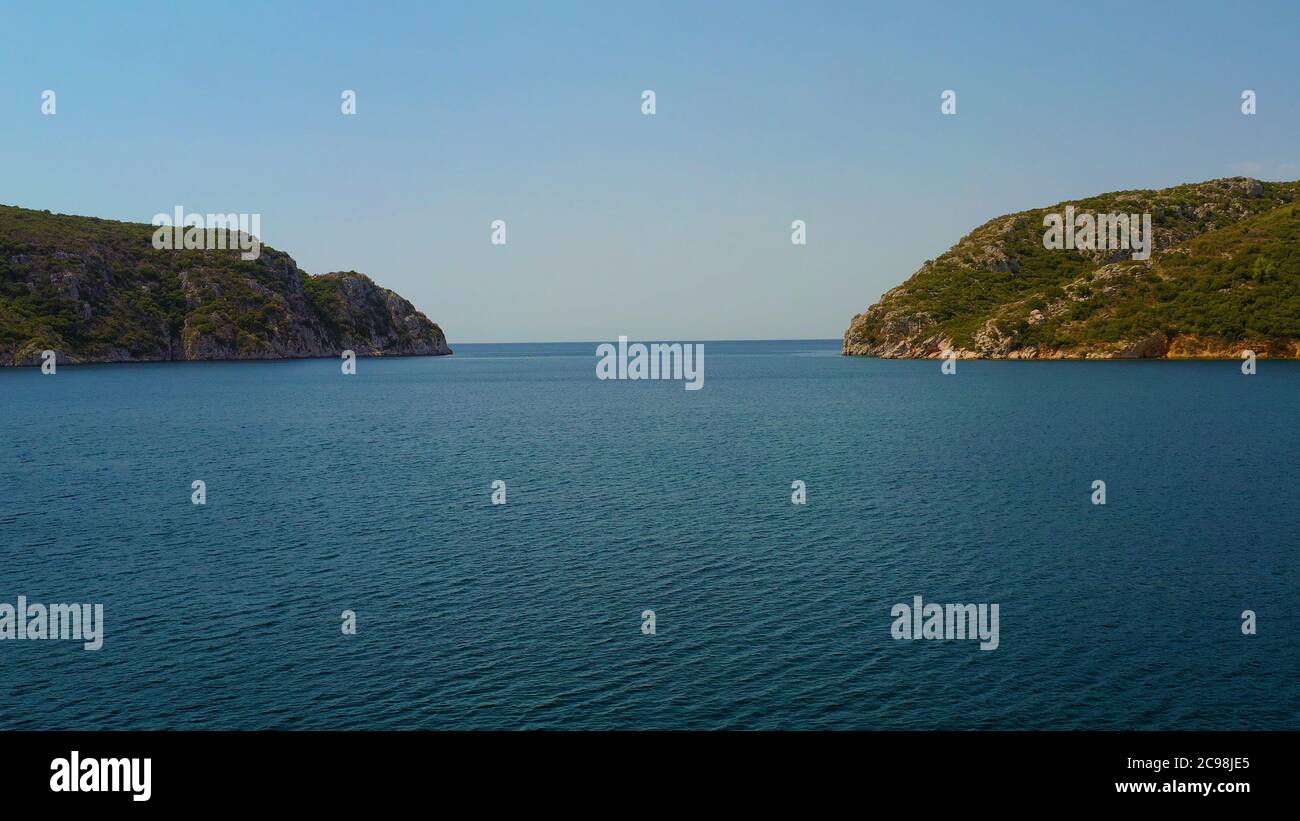 Aerial view of a blue ocean near a cliffy shore at daytime Stock Photo ...