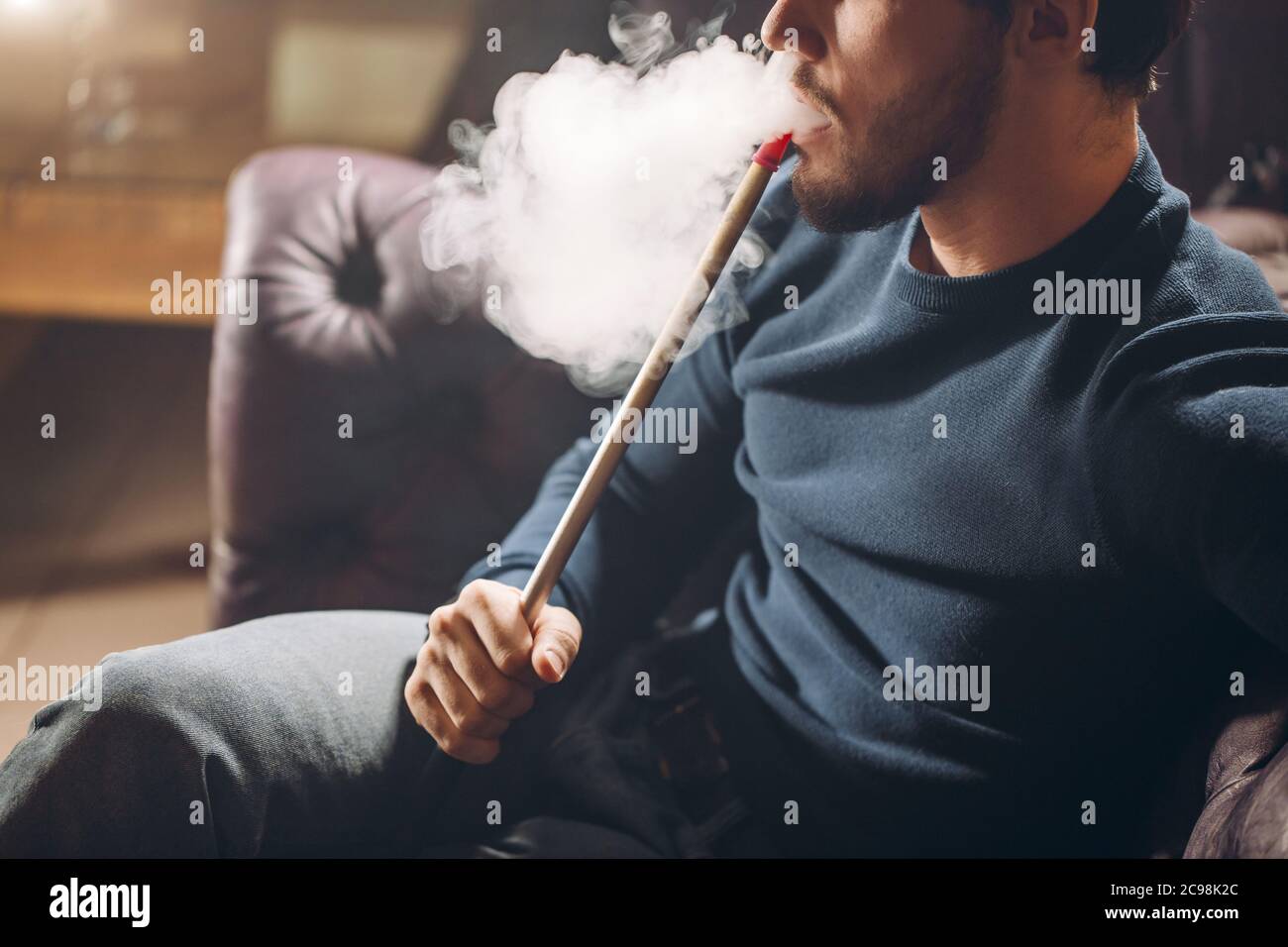 Young man blowing cigarette smoke hi-res stock photography and images ...