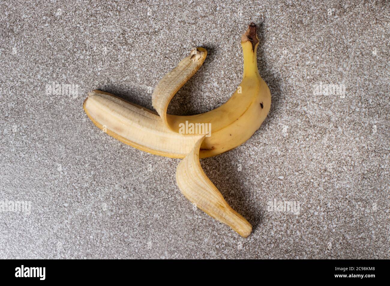 One ripe peeled banana on a gray background. The banana pulp Stock ...