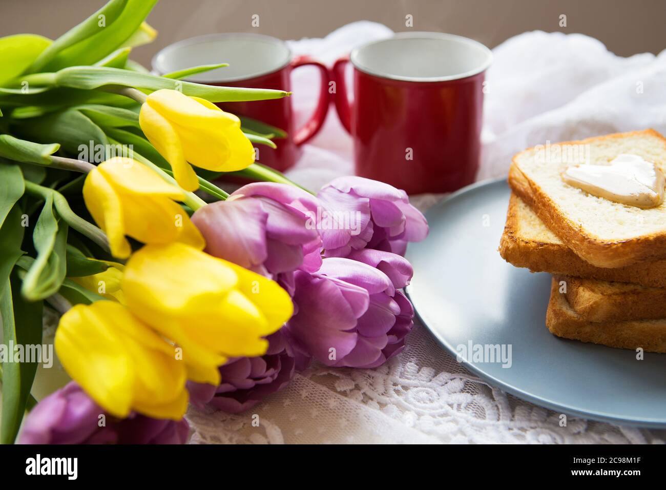 Homemade breakfast in bed. Toast with peanut butter, a cup of coffee ...