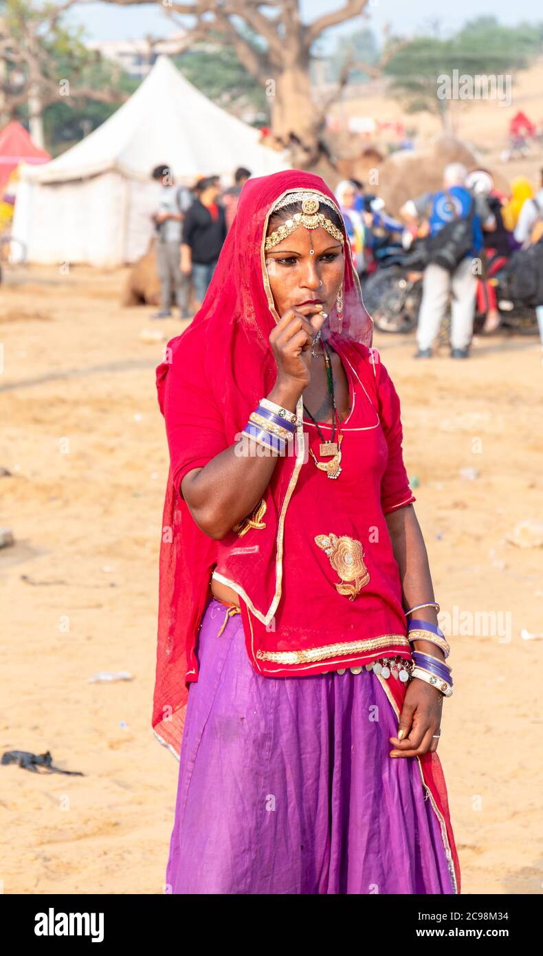 A portrait of Young Indian woman in ethnic dress and jewellery Smoking ...
