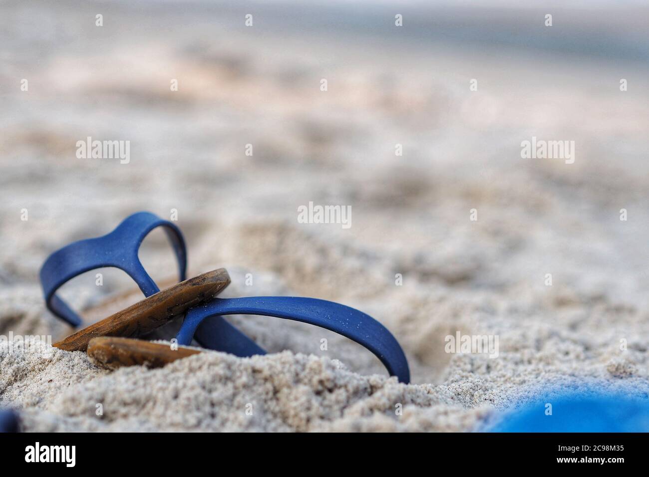 Blue Sandals on the beach Stock Photo - Alamy