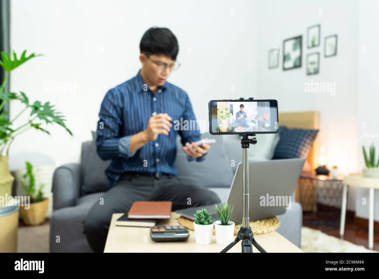 Young asian male blogger recording vlog video on camera review of ...