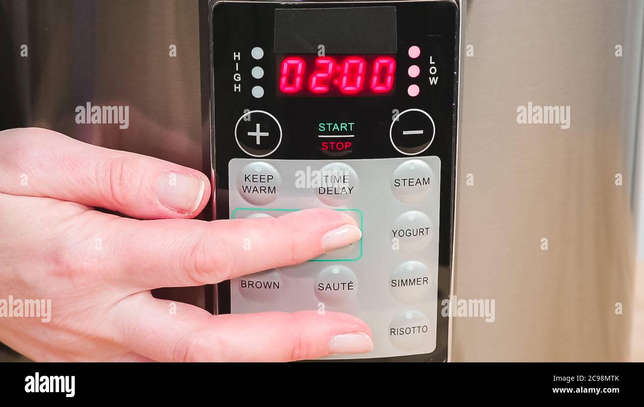 Cooking with modern electric pressure cooker Stock Photo - Alamy