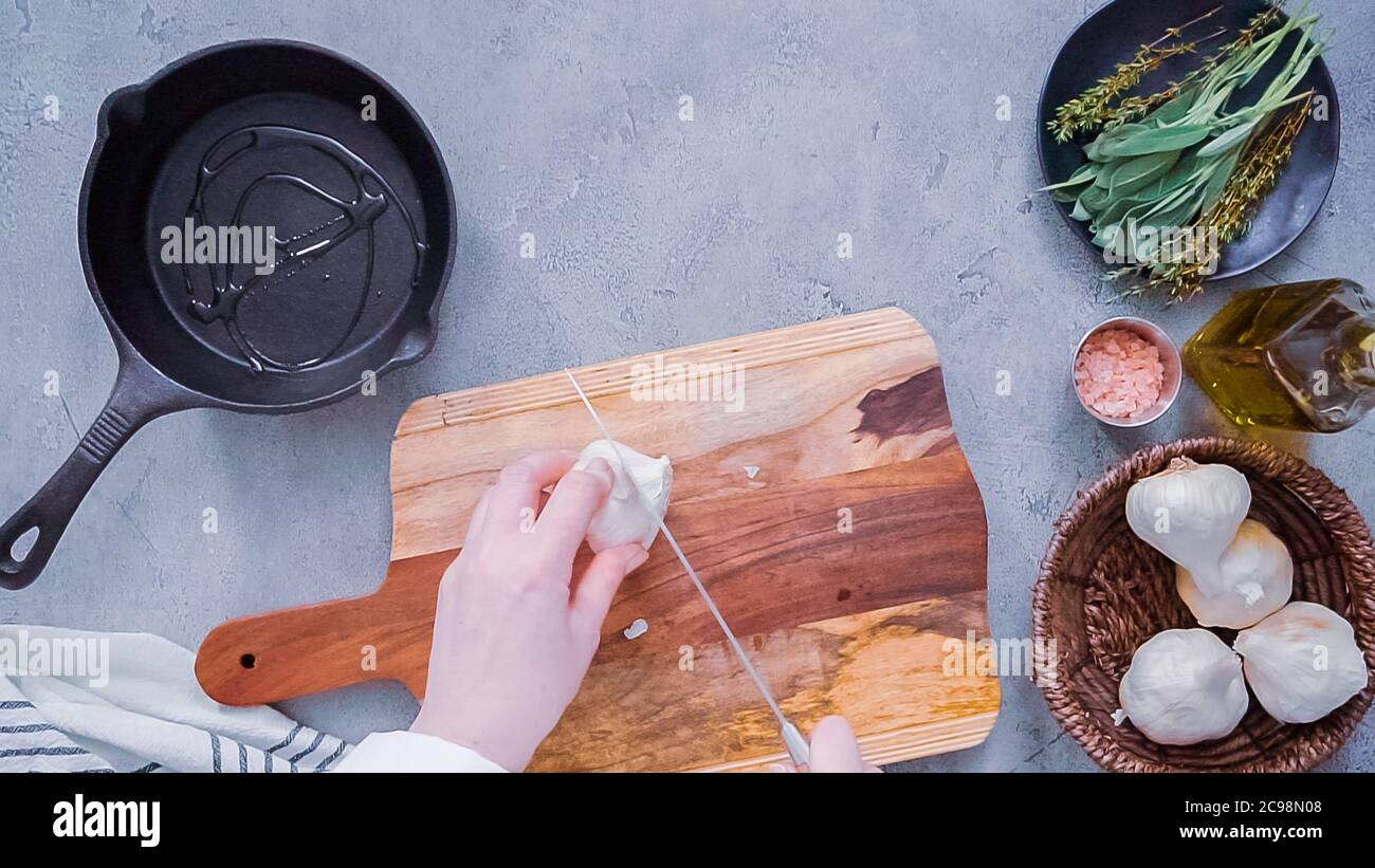 Flat lay. Preparing garlic spread by roasting garlic with fresh spices ...