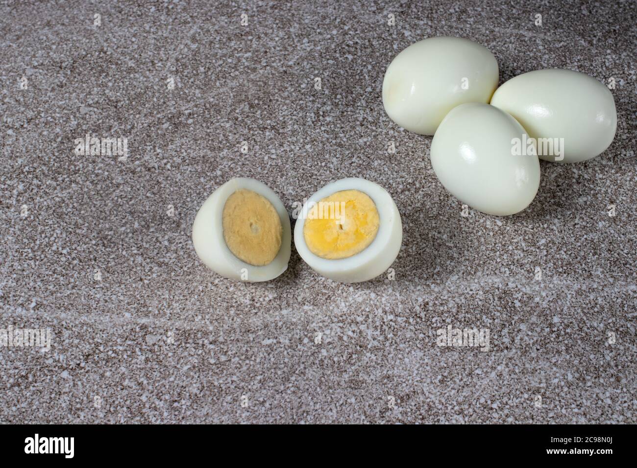 Boiled peeled eggs without shell on a gray background. Ingredients for ...