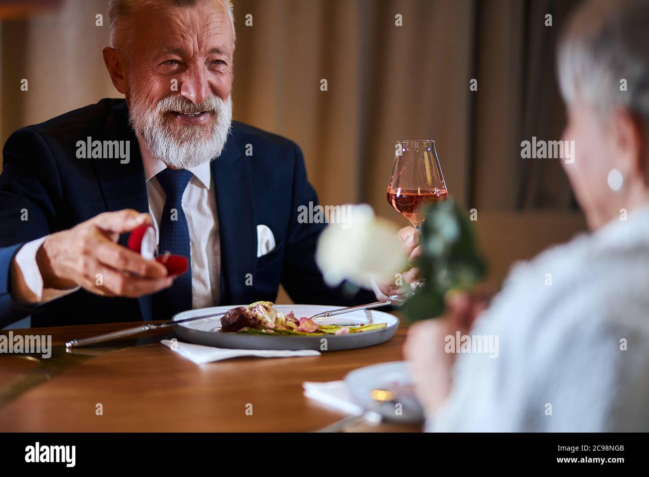 Senior Man Happily Looks At Woman Waiting Answer For Marriage Proposing