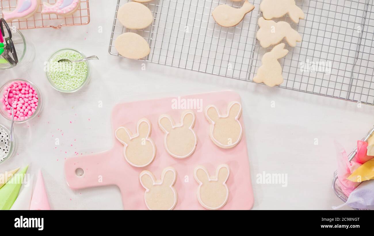 Step by step. Flat lay. Decorating Easter sugar cookies with rotal ...