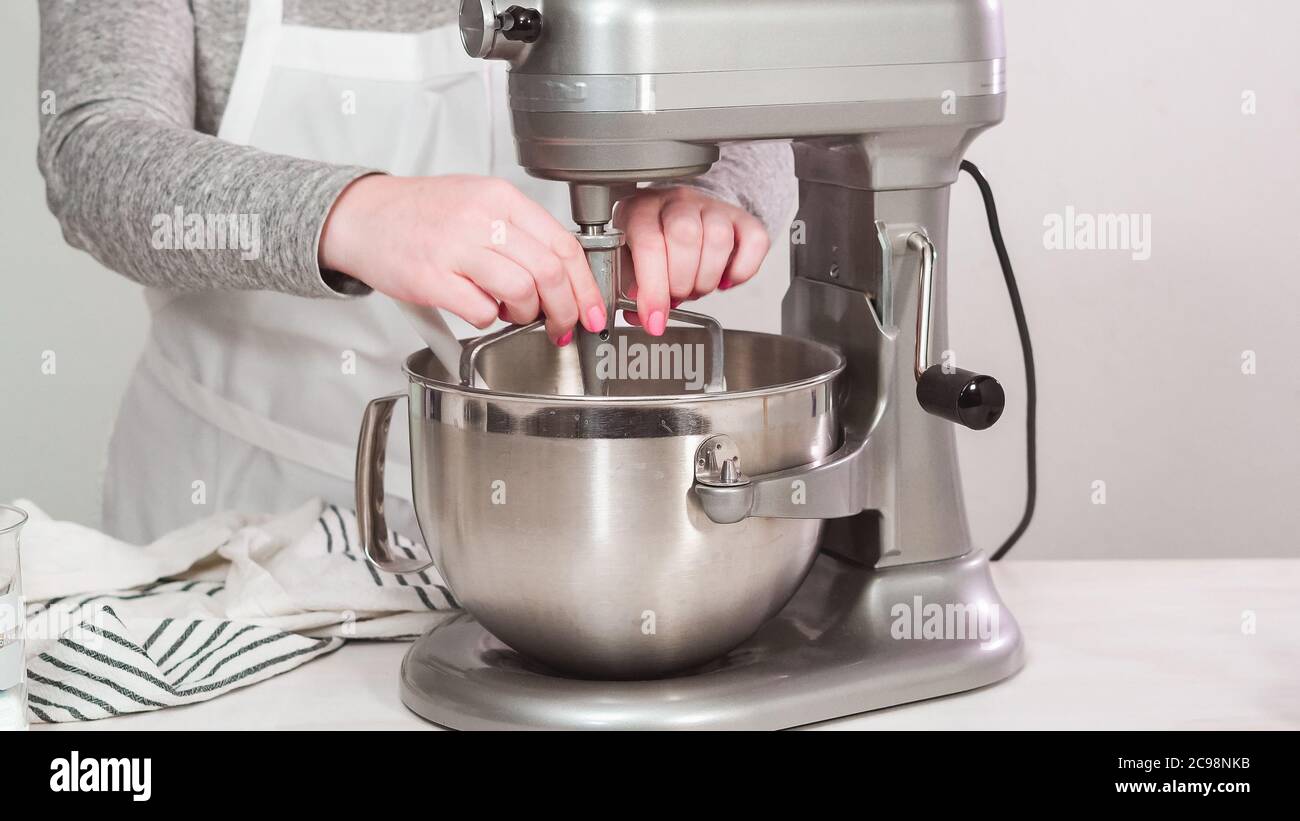 Step by step. Flat lay. Mixing royal icing in electric kitchen mixer ...