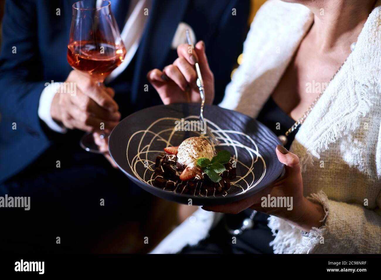 High european cuisine. People eat sweet dessert from beautiful dish and ...