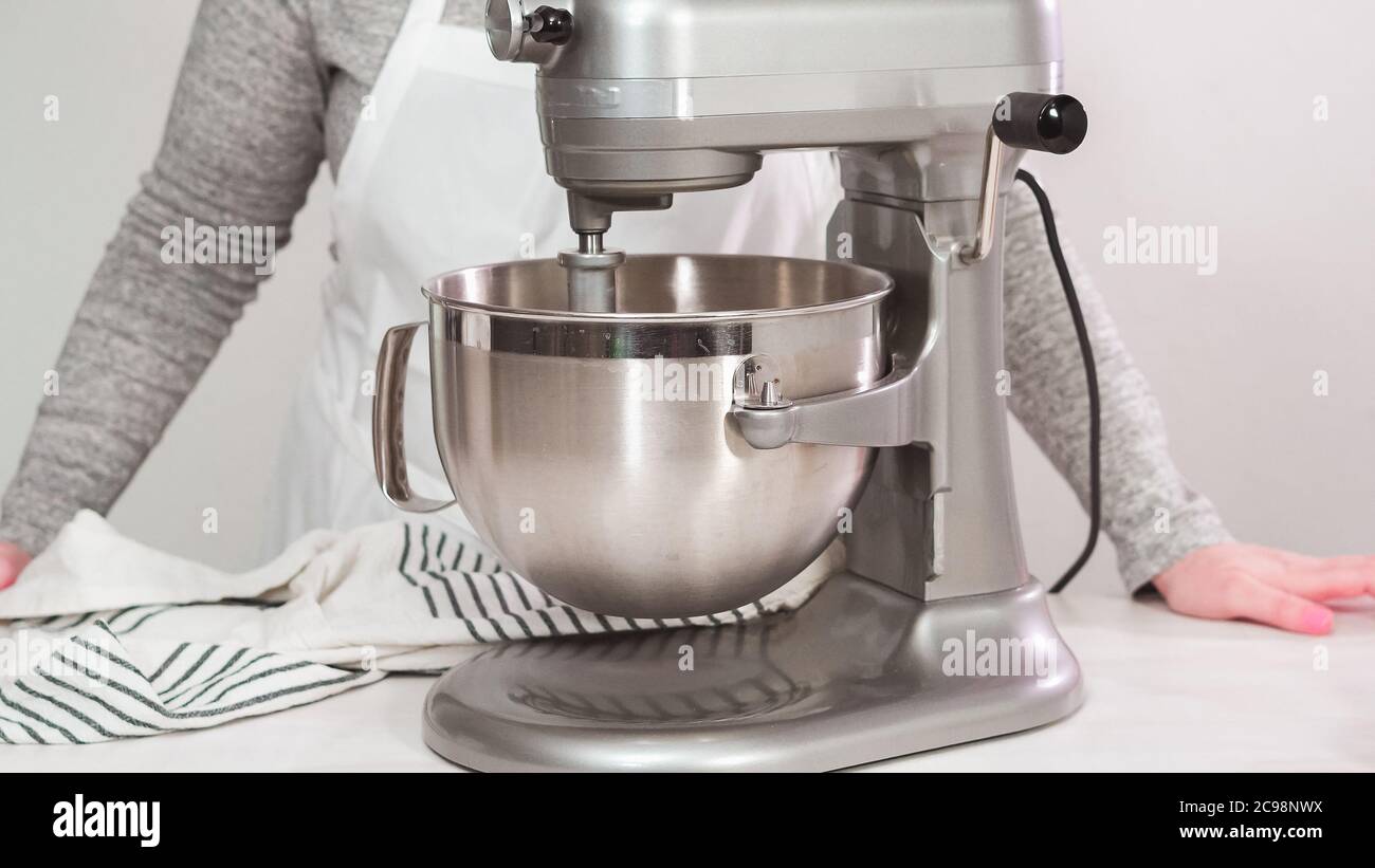 Step by step. Flat lay. Mixing royal icing in electric kitchen mixer ...