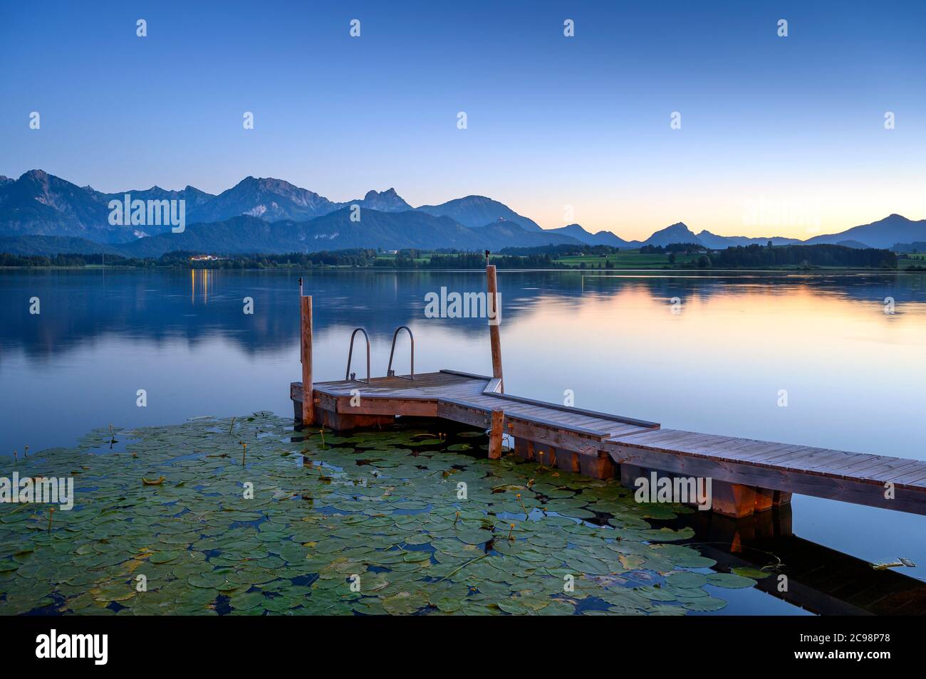 Wooden footbridge at Hopfensee with the Tannheim mountains in the ...