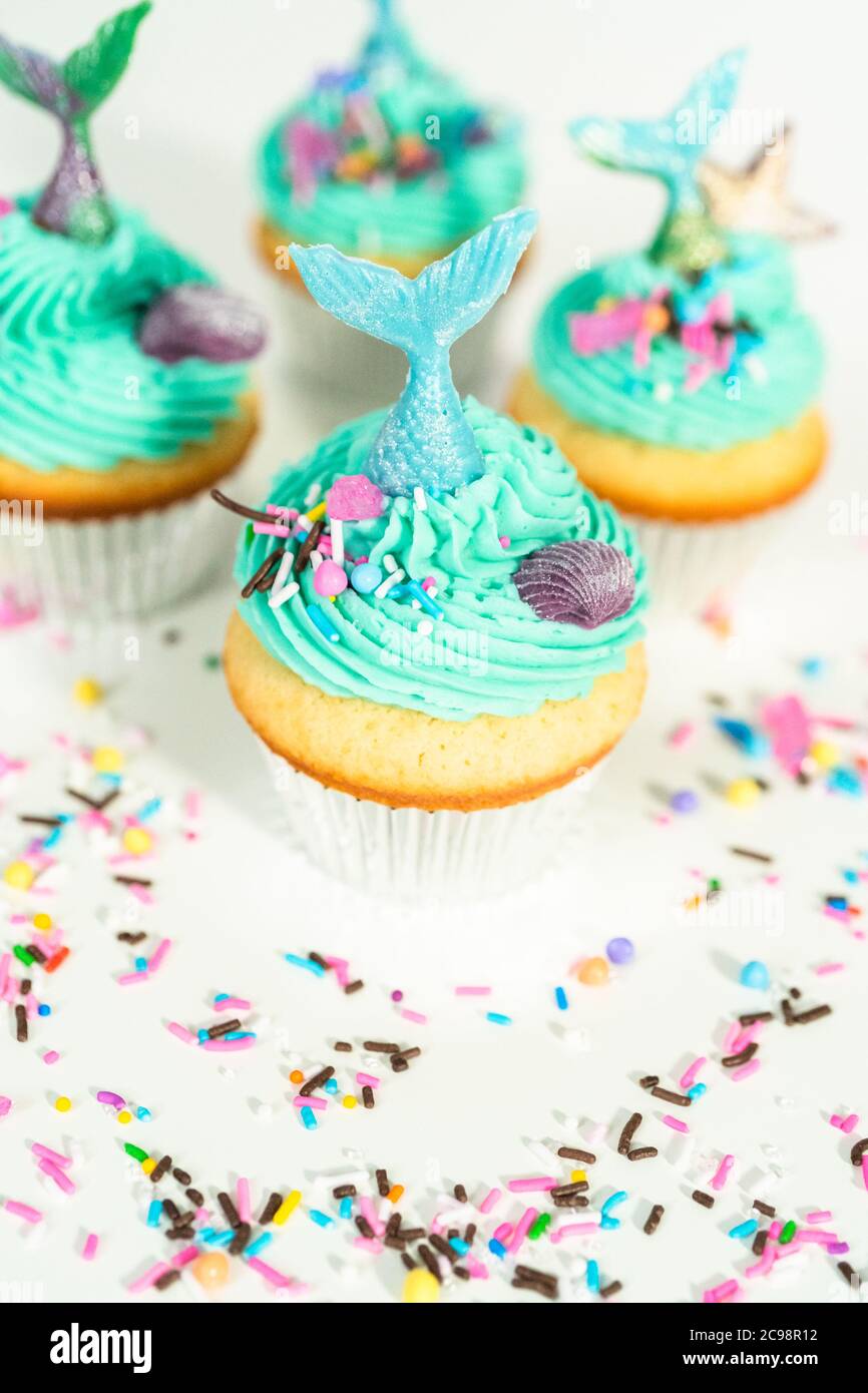 Gourmet mermaid cupcakes topped with blue buttercream frosting and ...