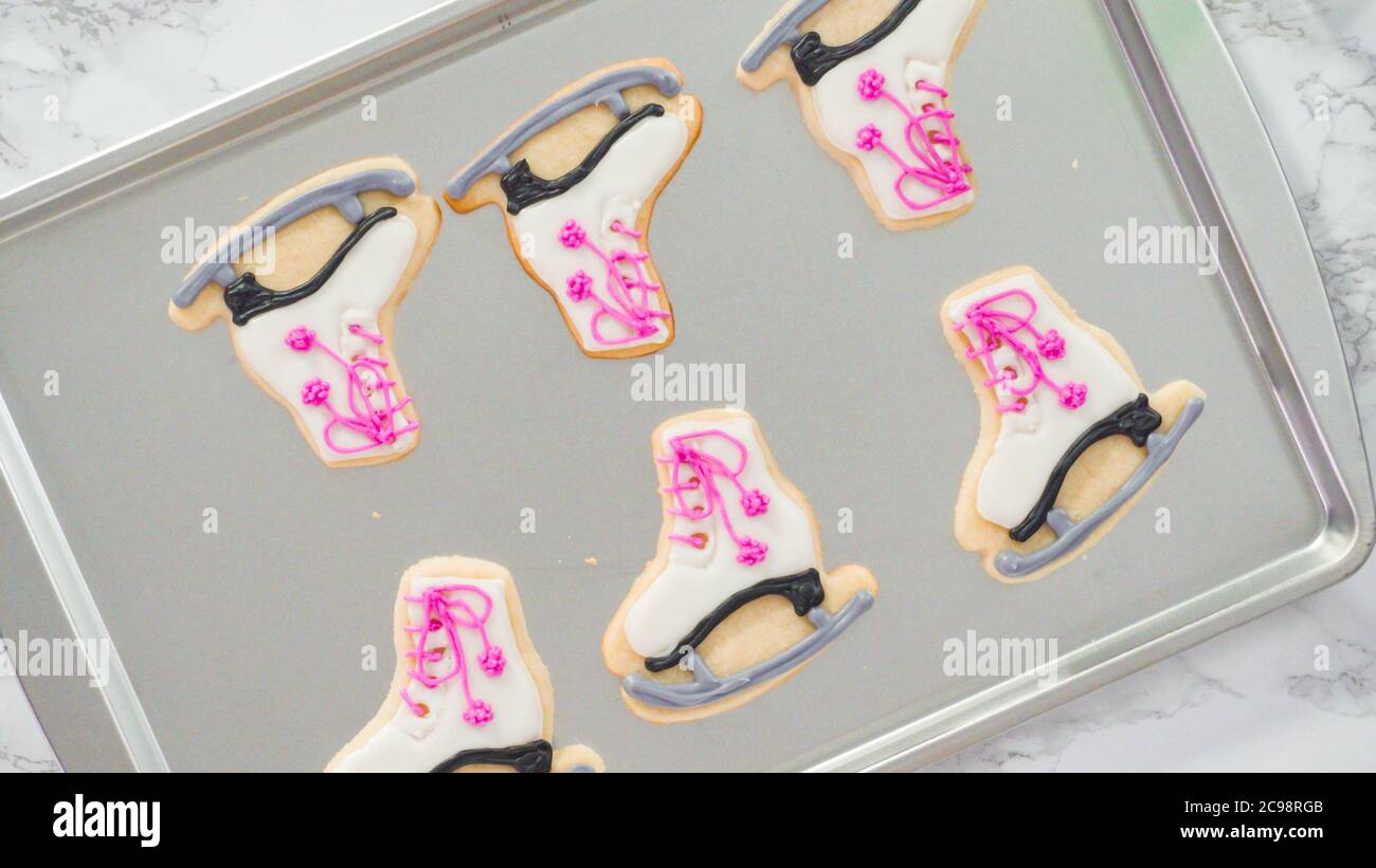Flat lay. Icing figure skate shaped sugar cookies with royal icing ...