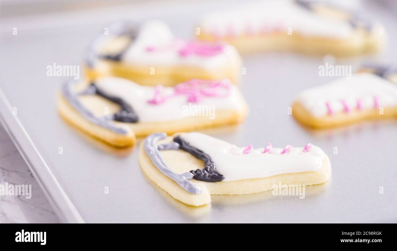 Icing figure skate shaped sugar cookies with royal icing Stock Photo ...