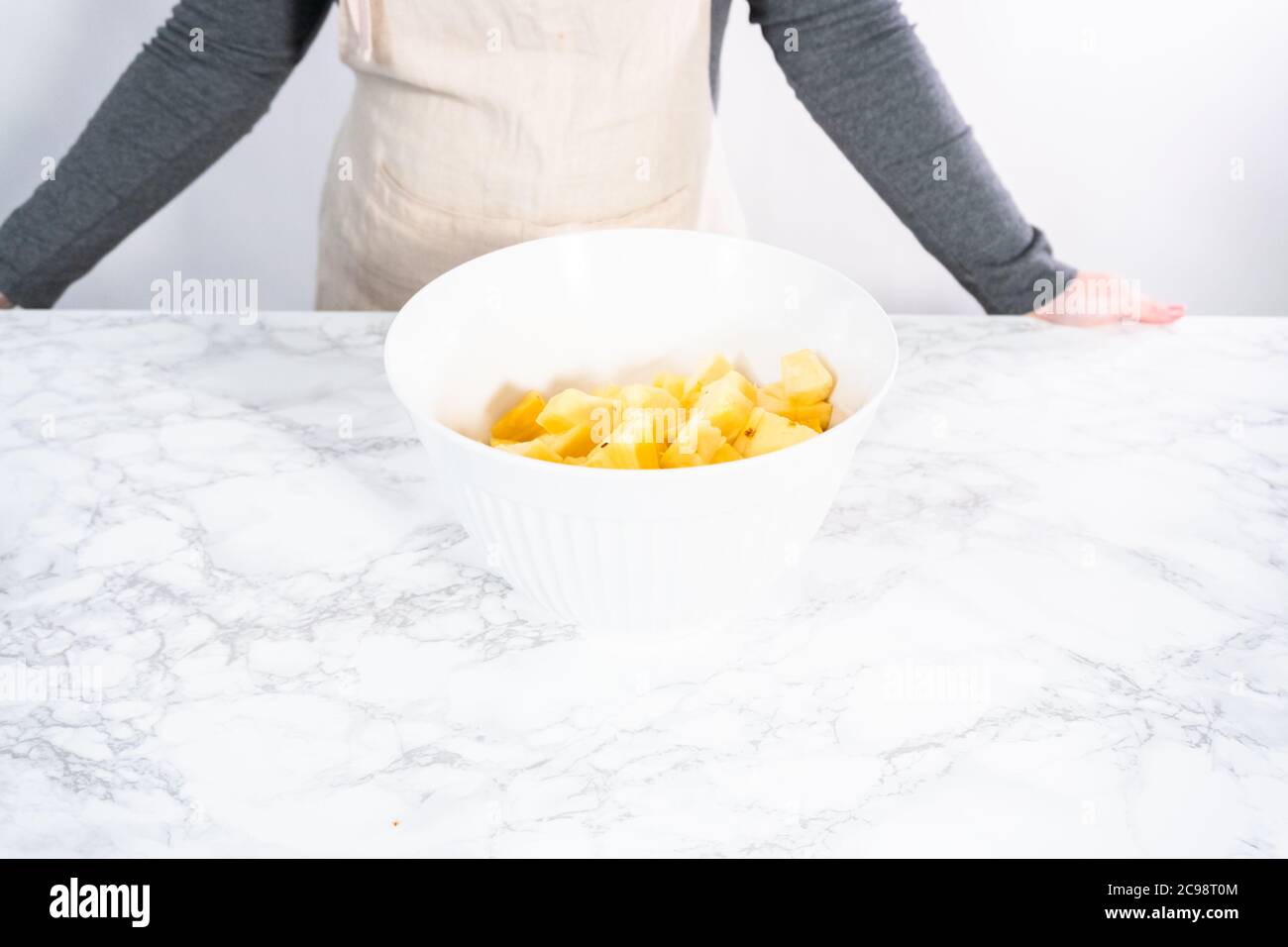Cleaning and cutting a pineapple into the small pieces Stock Photo - Alamy