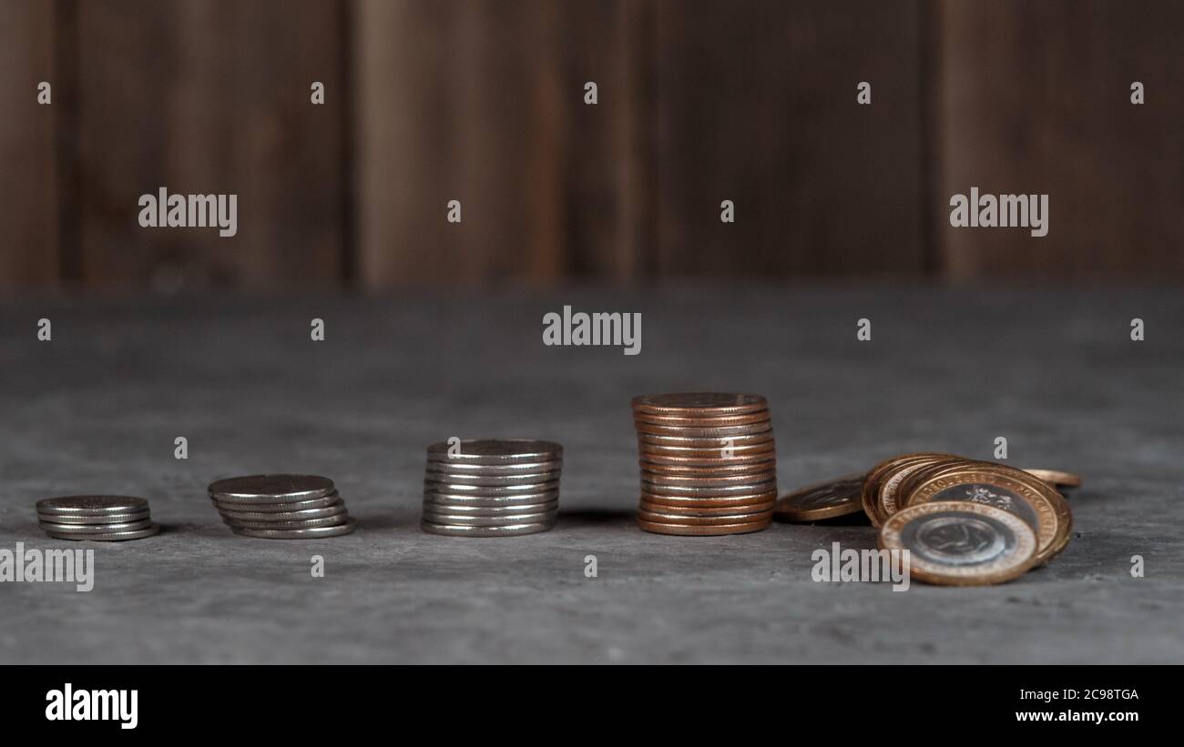 global financial crisis. stacks of coins with falling Stock Photo - Alamy