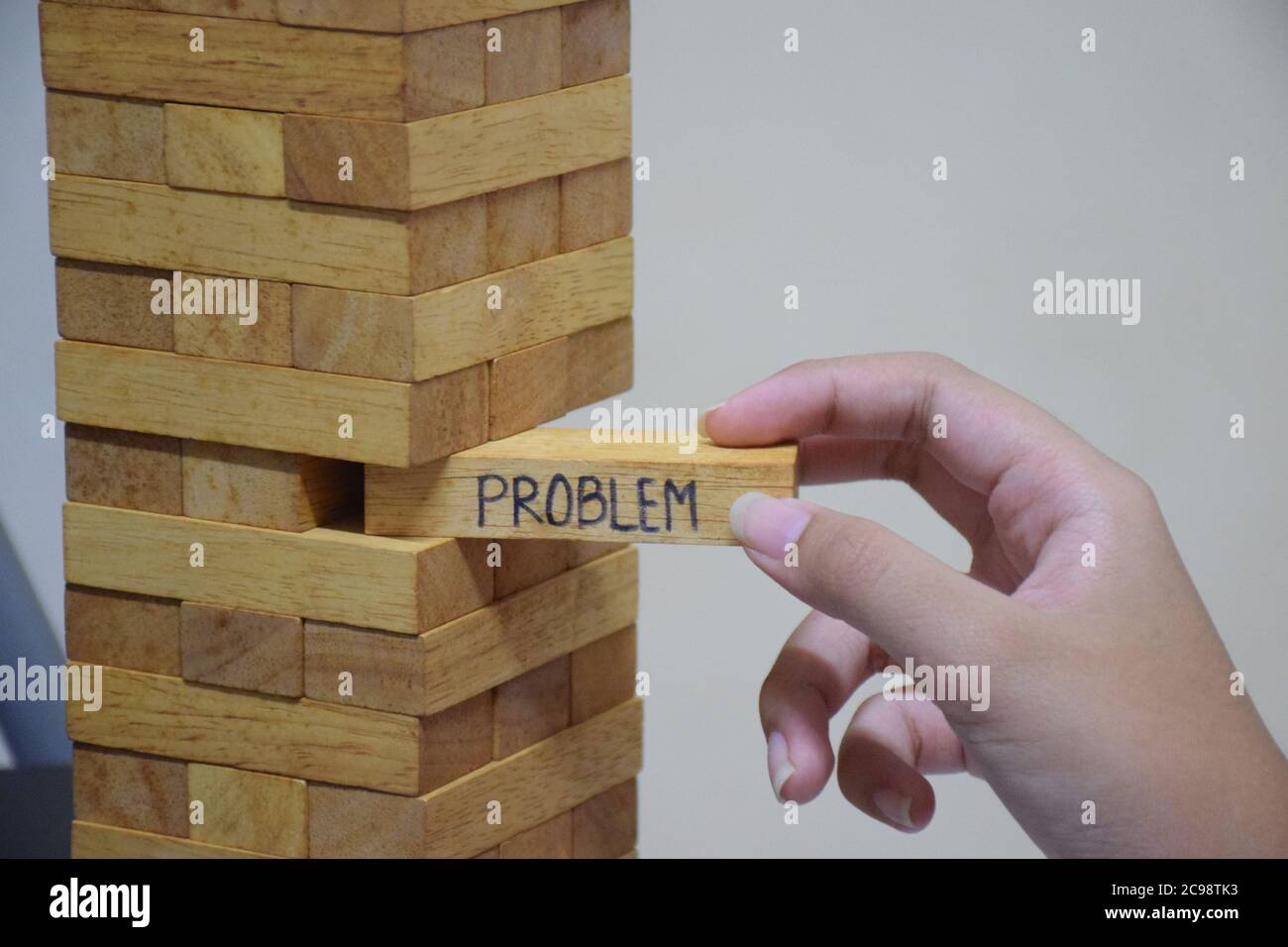 Take out the problem - Jenga Game of physical skill Stock Photo - Alamy