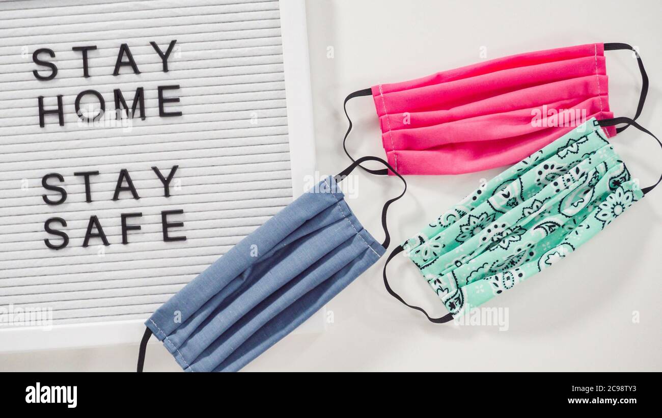 Flat lay. STAY HOME and STAY SAFE sign on message board with a homemade ...