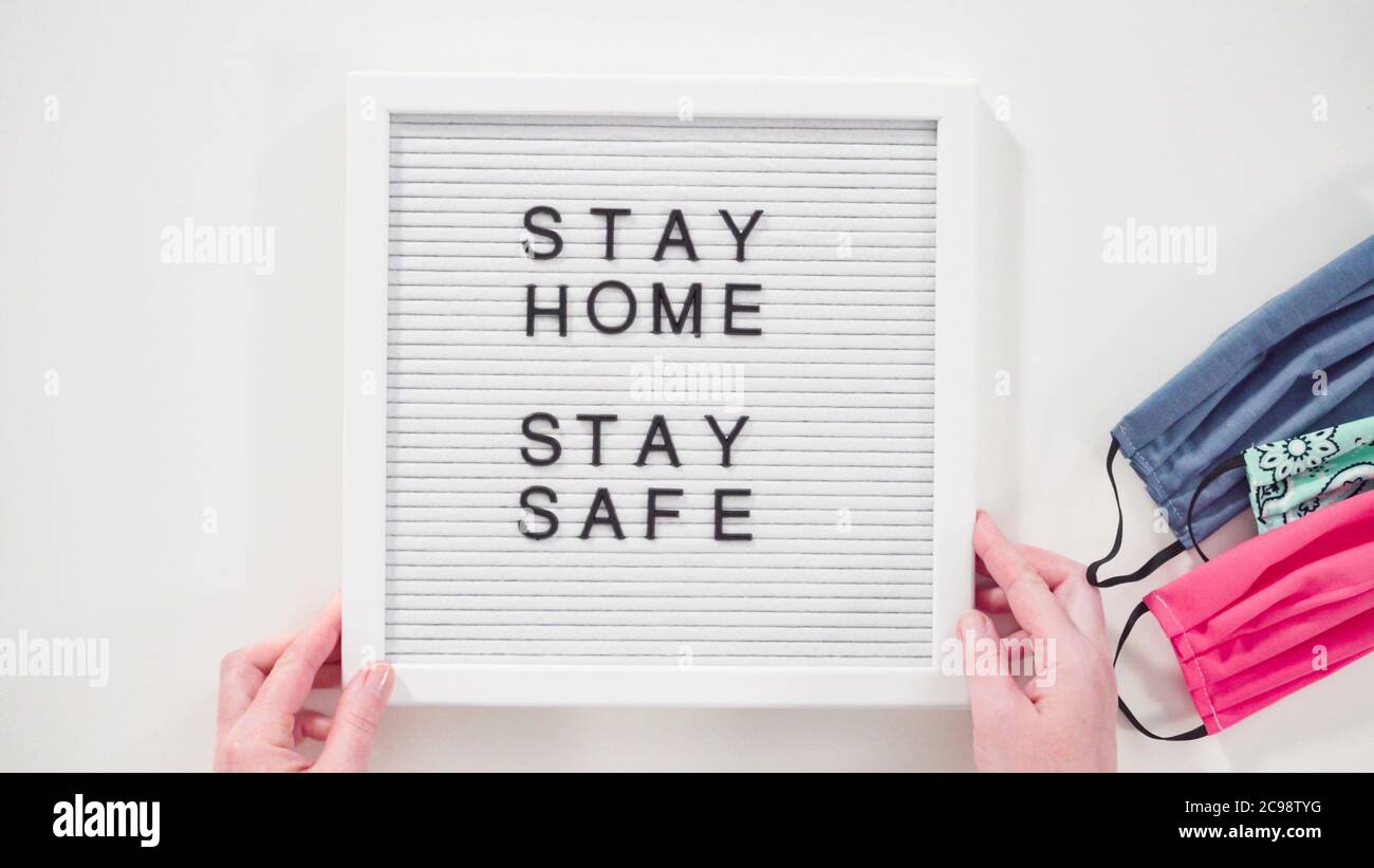 Flat lay. STAY HOME and STAY SAFE sign on message board with a homemade ...