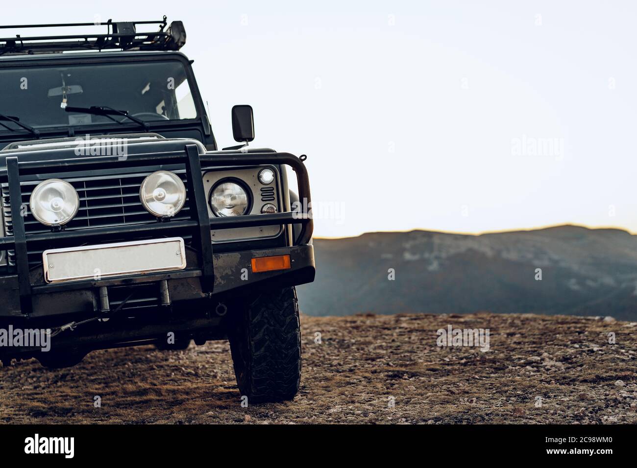 Dark green off-road car in the mountains Stock Photo - Alamy
