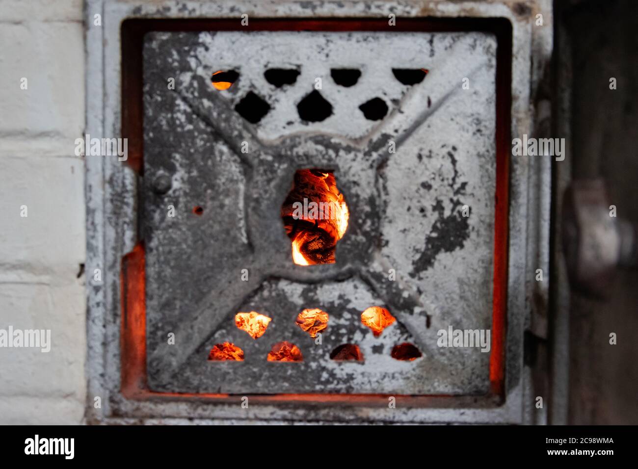 Blazing and warming fire in the stove through the closed door Stock ...