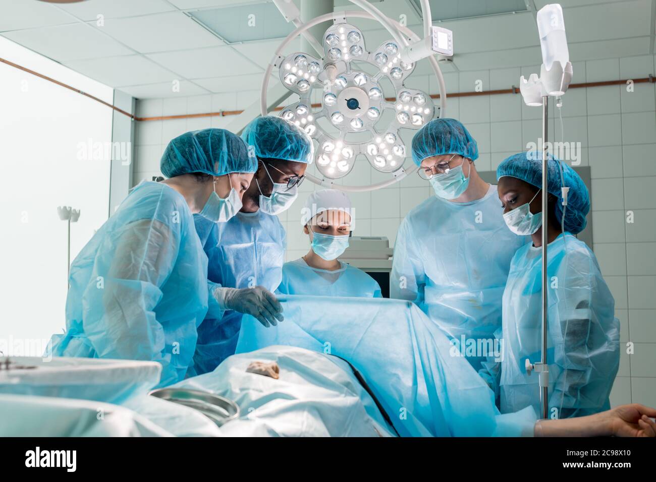 serious doctors has finished to perfor difficult surgery, they are ...