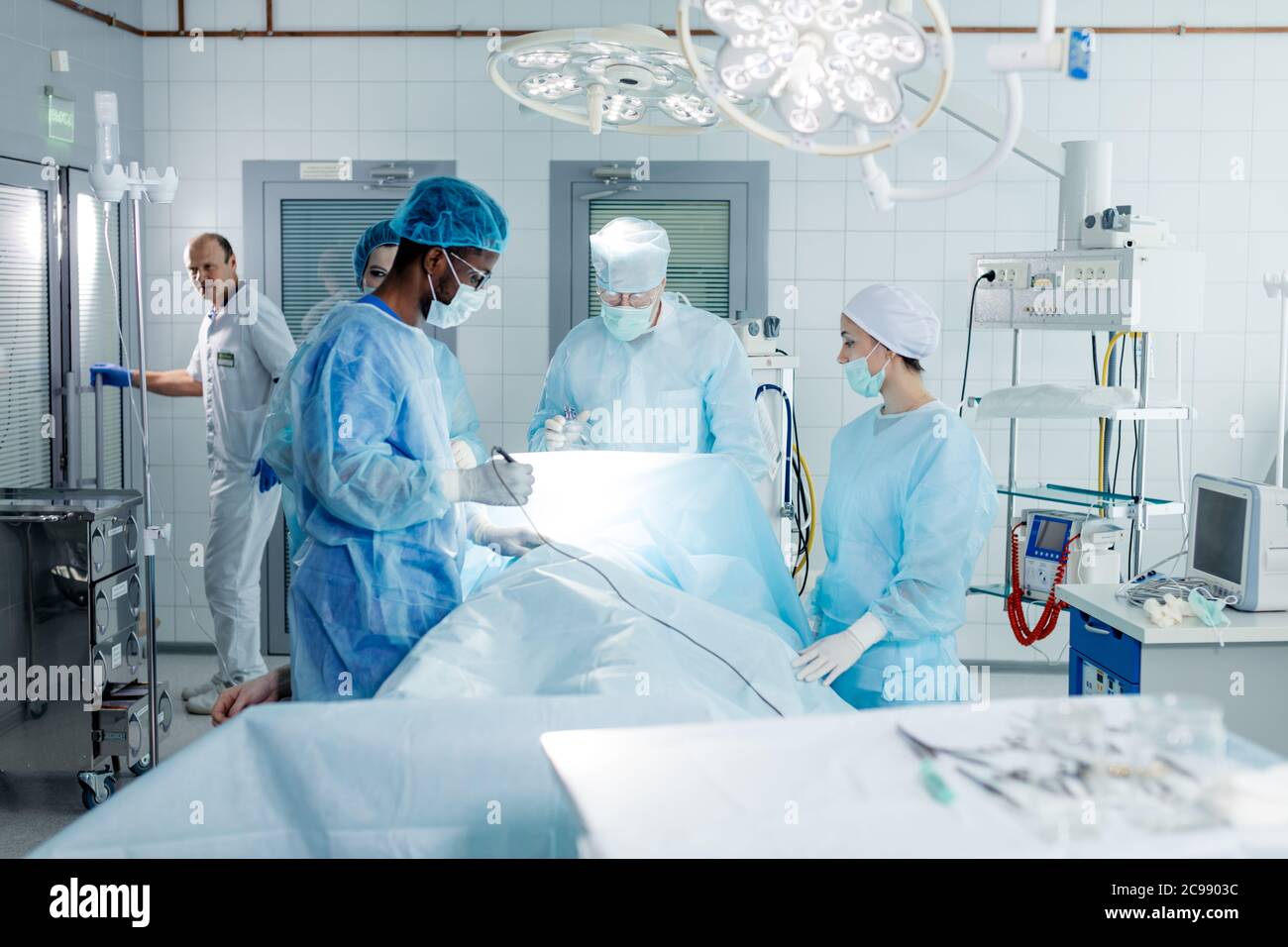 Experienced African doctor and his team perform the surgery with modern ...