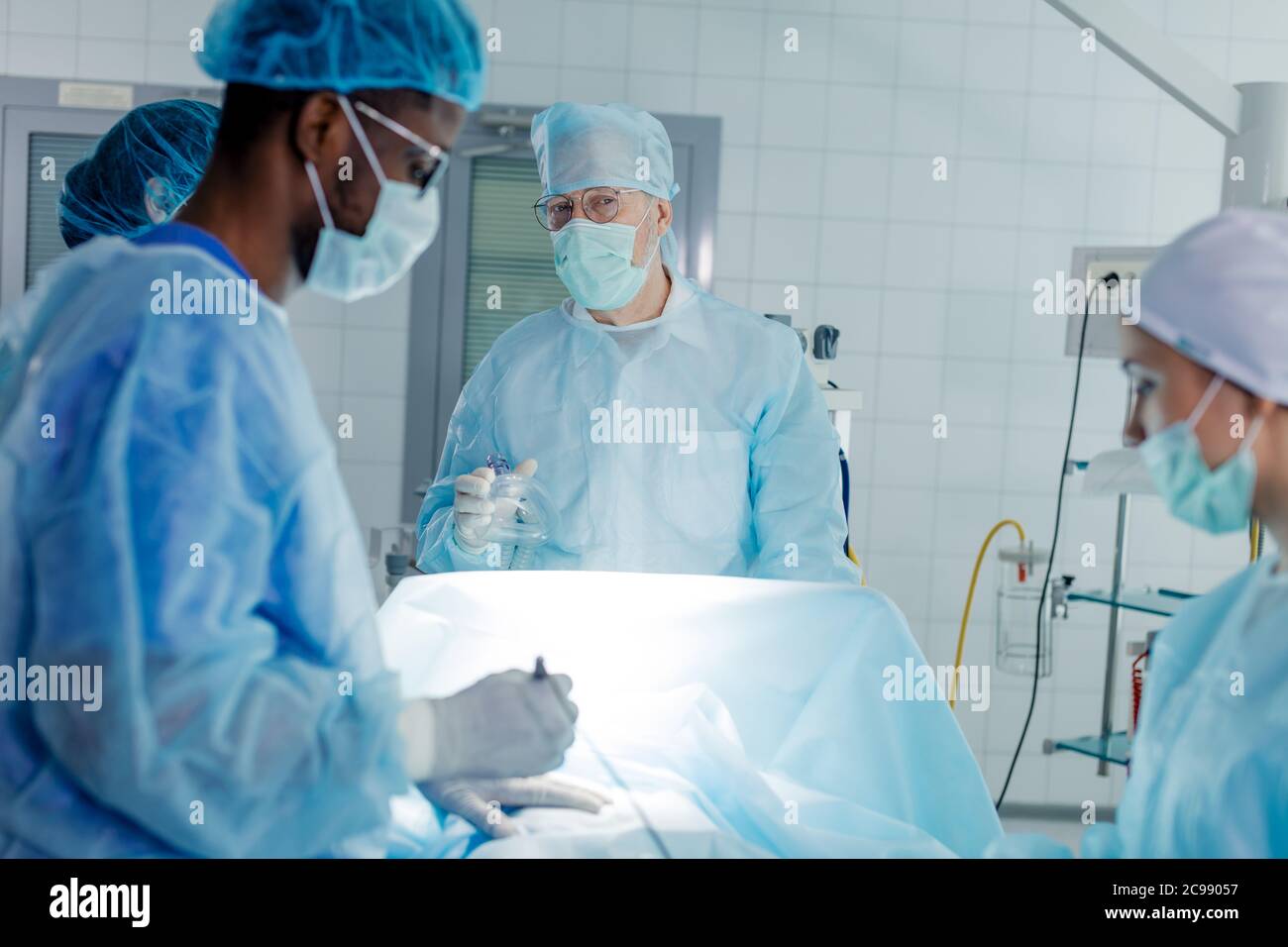 professional talented surgeon standing behind the bed and posing to the ...