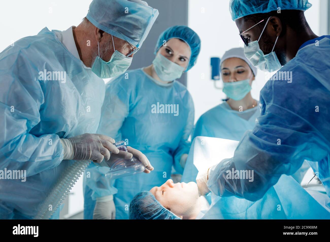 highly-trained medical and nursing staff working in the operating room ...