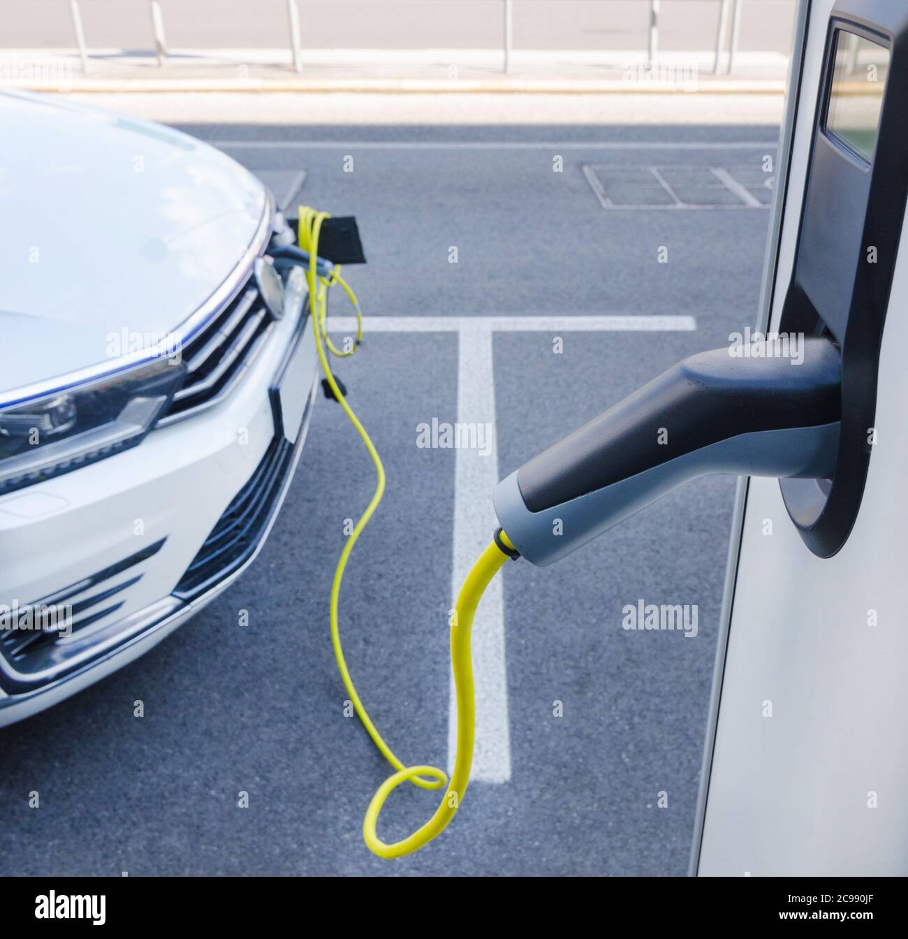 Modern electric car plugged in charging on the street station. New ...